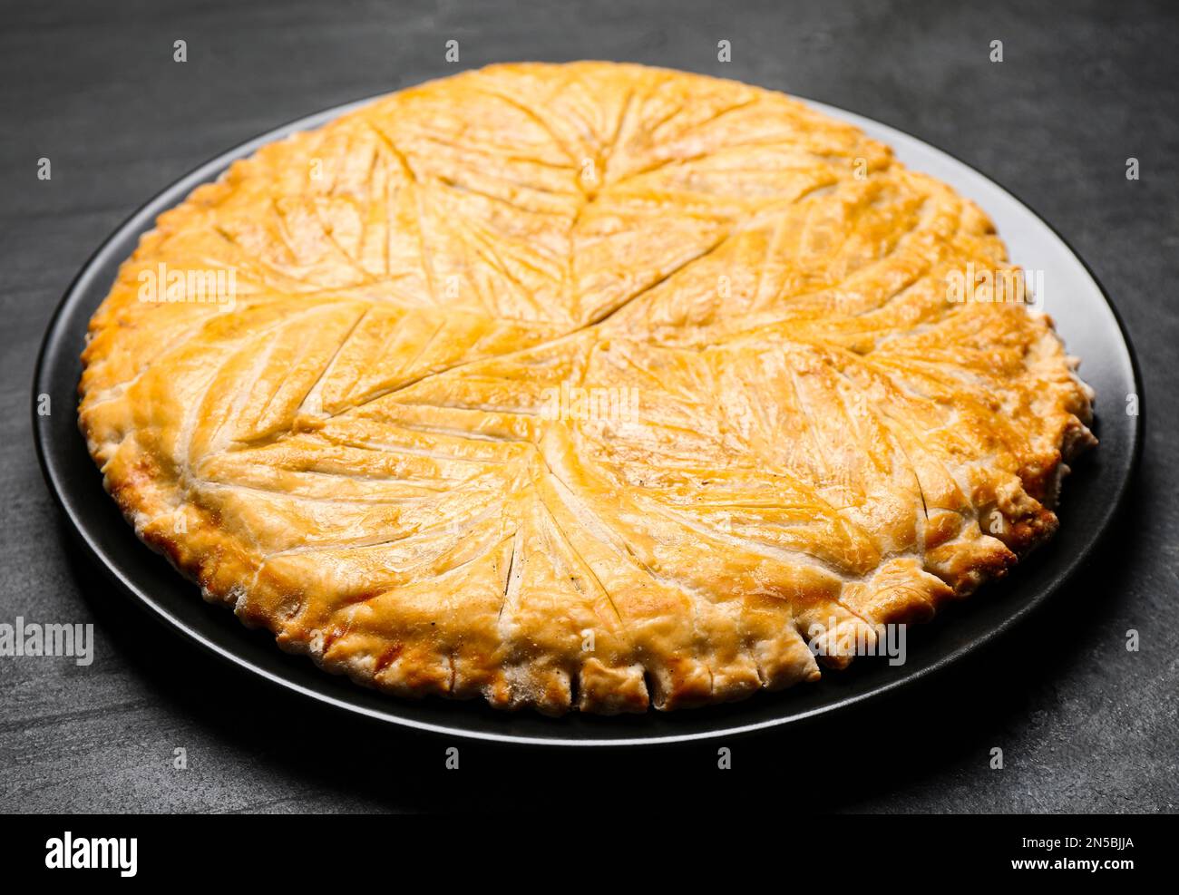 Traditional galette des rois on black table, closeup Stock Photo - Alamy