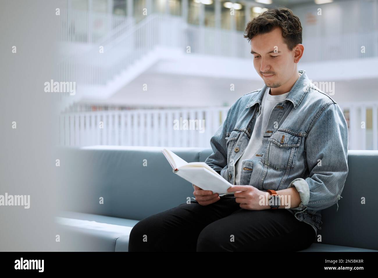 Reading, books and relax man in library for university, college or ...