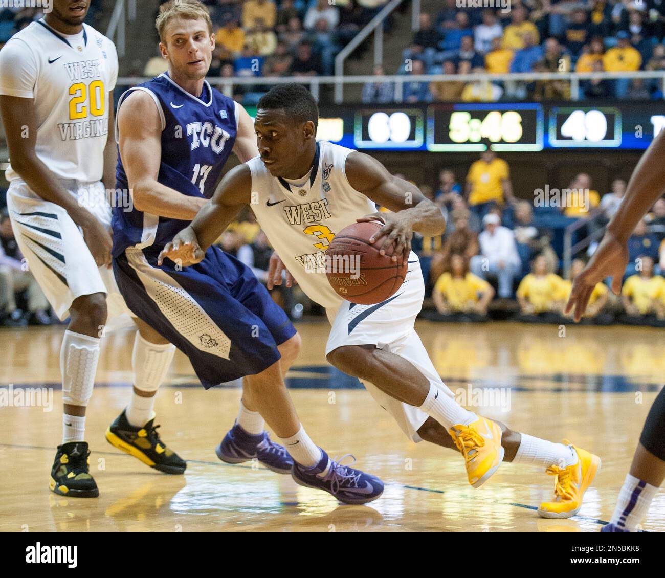 West Virginia's Juwan Staten, right, drives past TCU's Christian Gore ...