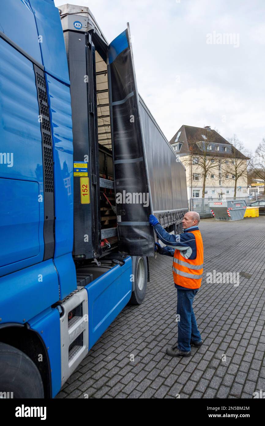 Freight traffic, professional drivers when opening the truck tarpaulin ...