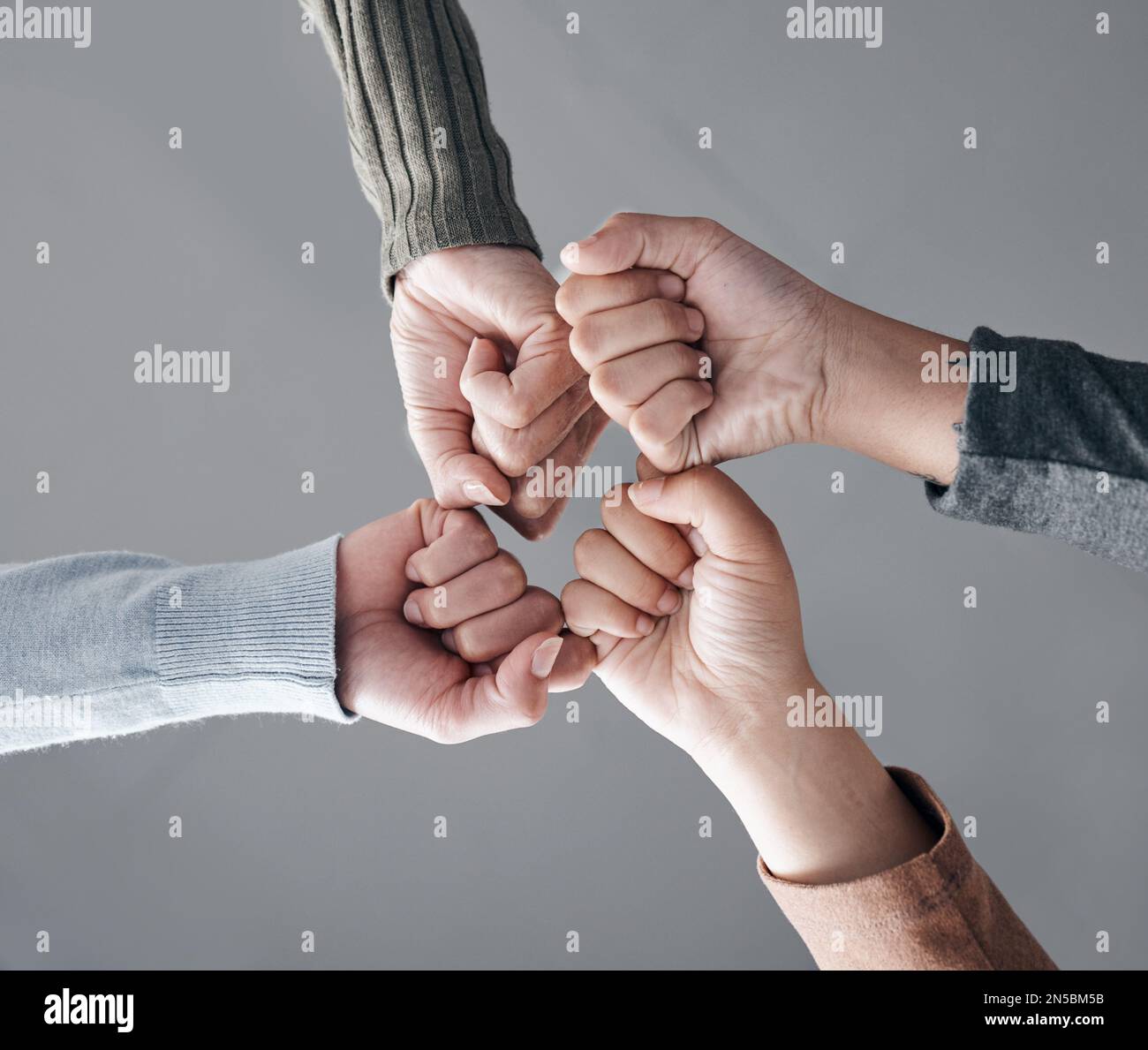 People, hands and fist bump in trust for unity, collaboration or team ...
