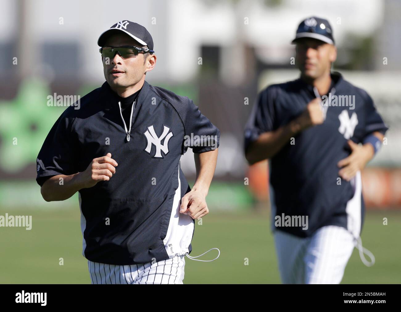 New York Yankees right fielder Ichiro Suzuki, left, runs in the ...