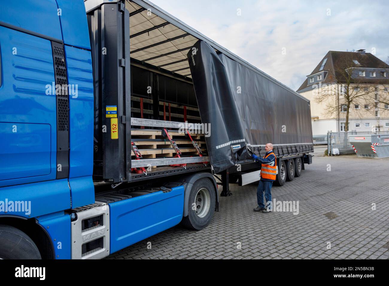 Freight traffic, professional drivers when opening the truck tarpaulin ...
