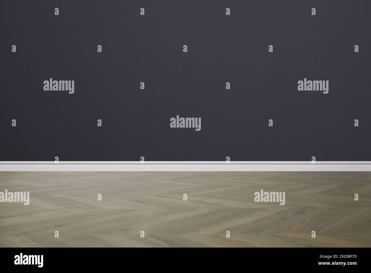 Wooden floor and empty dark wall indoors Stock Photo - Alamy