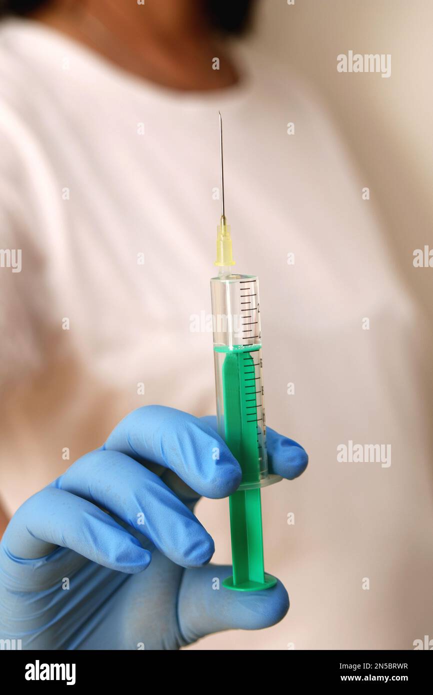injection, disposable plastic syringe with disposable needle in a hand ...