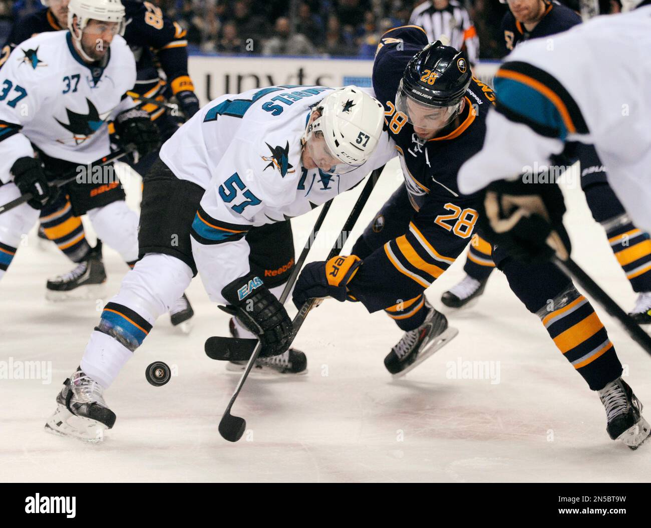 San Jose Sharks center Tommy Wingels (57) wins a face-off against Buffalo Sabres center Zemgus ...