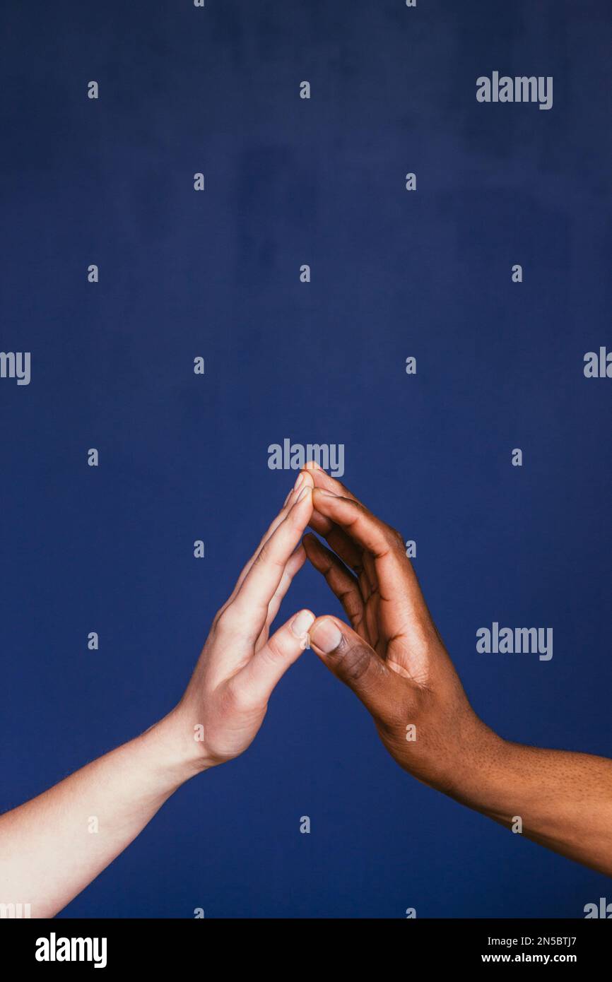Two hands together, black and white race contrast Stock Photo - Alamy