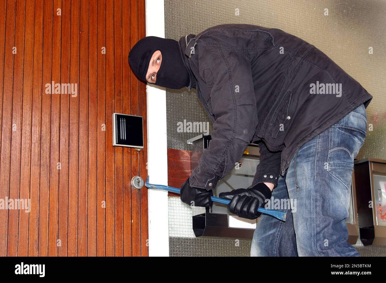 burglar with a crowbar on a front door Stock Photo - Alamy