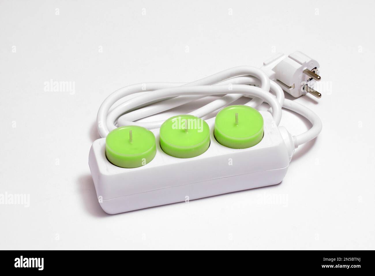 power socket with green tea candles, saving energy Stock Photo - Alamy