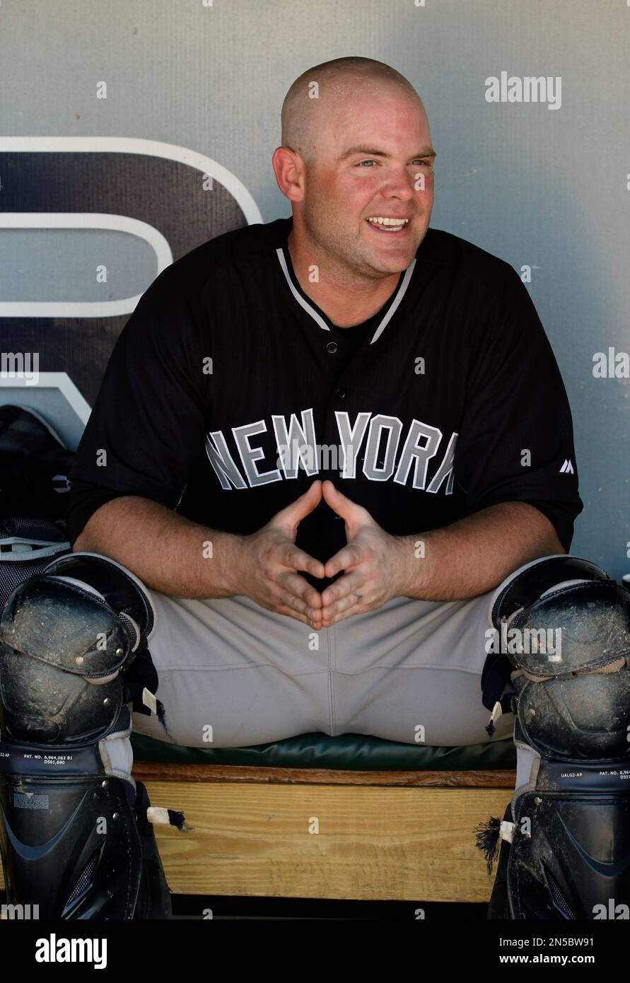 New York Yankees catcher Brian McCann sits in the dugout between innings of an exhibition spring ...