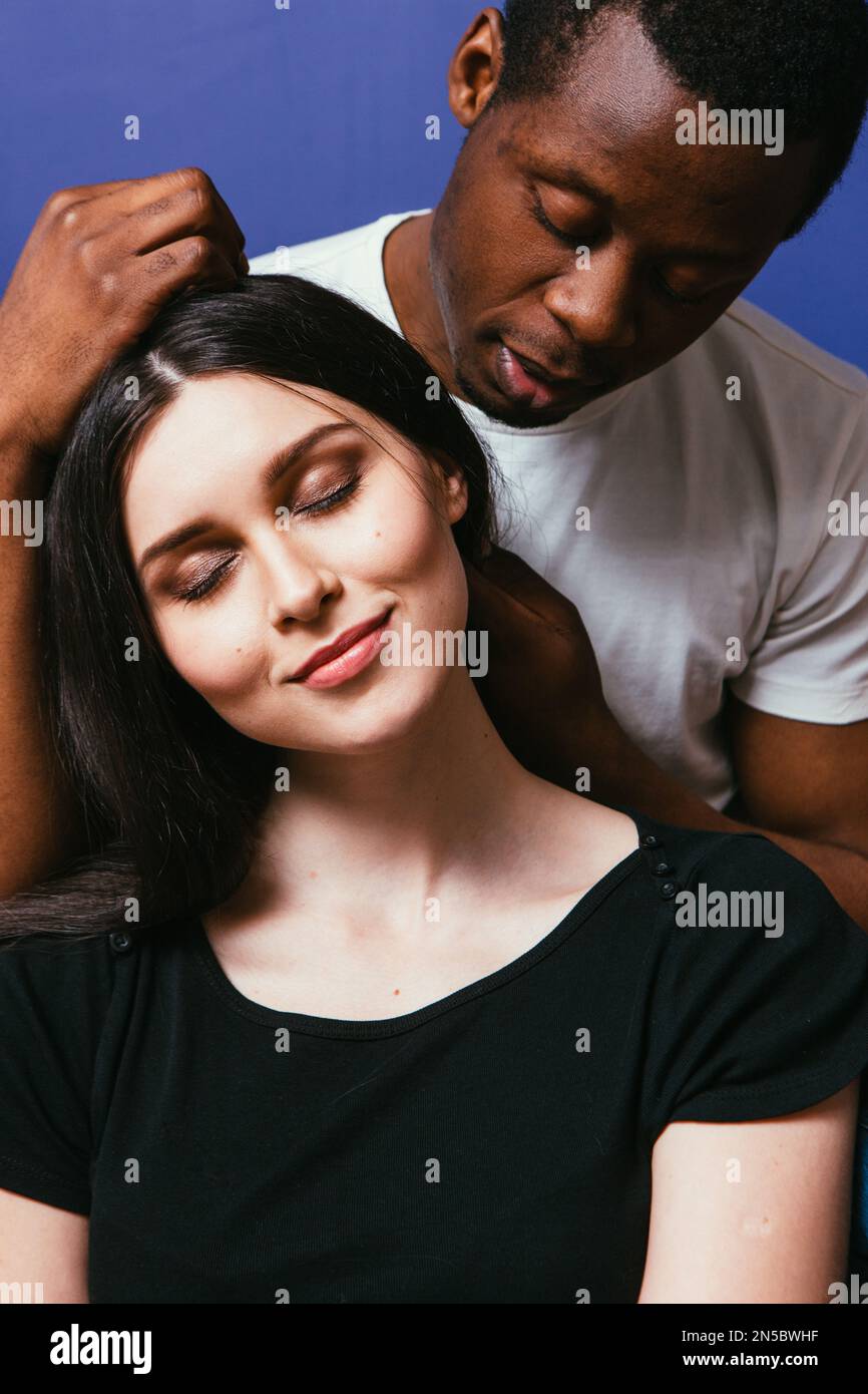 Black man caress white woman hair, couple in love Stock Photo - Alamy