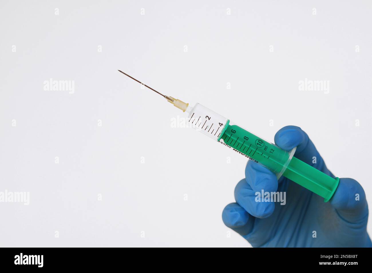 injection, disposable plastic syringe with disposable needle in a hand ...