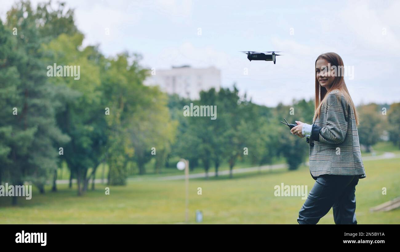 A cute girl controls a drone in the park Stock Photo - Alamy
