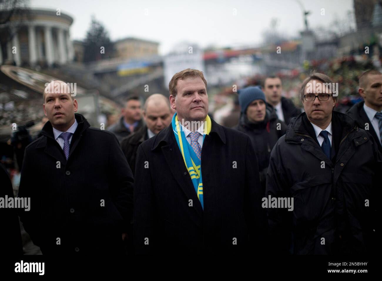 Canada's Minister of Foreign Affairs John Baird, center, walks in Kiev ...
