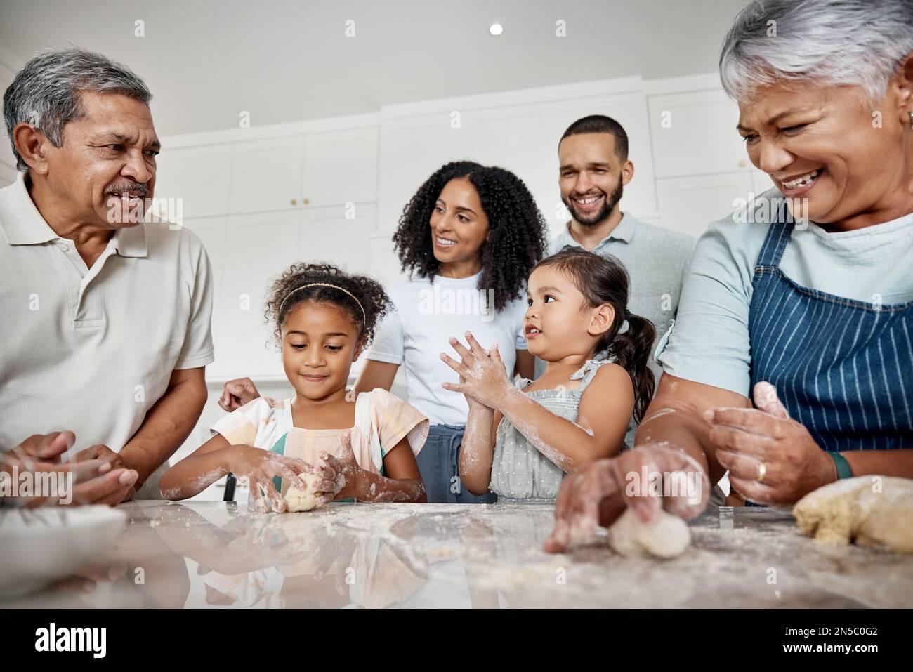 Cooking, learning and big family with kids in kitchen baking dessert or ...