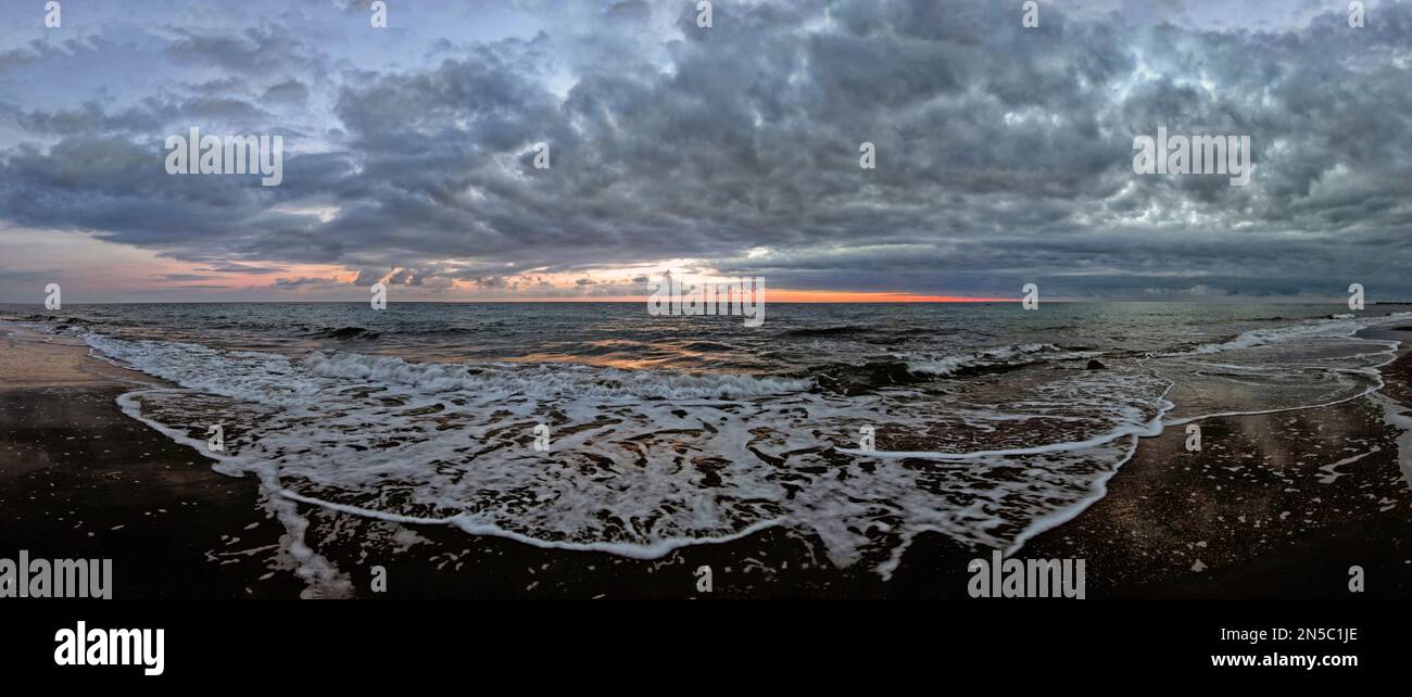 Panoramic seaside sunset at winter season with dramatic sky with dark ...
