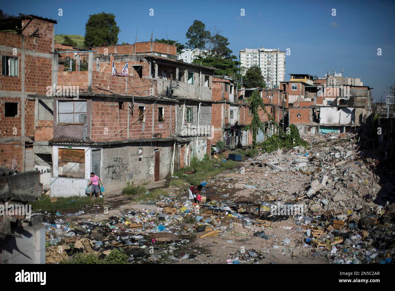 In this Jan. 9, 2014 photo, trash fills an area in the Favela do Metro ...