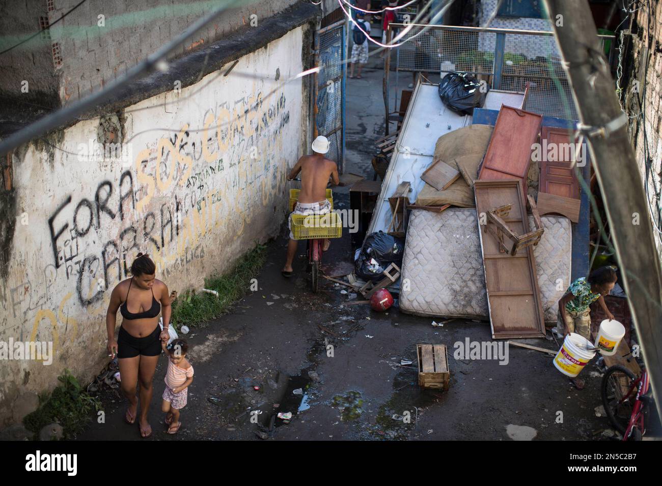 In this Jan. 9, 2014 photo, residents walk inside the Favela do Metro ...