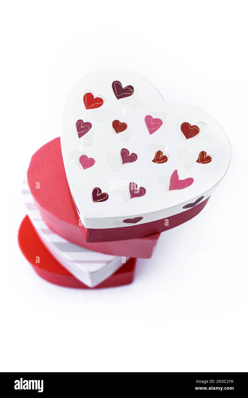 Heart shaped boxes decorated with pink and red hearts isolated on white ...