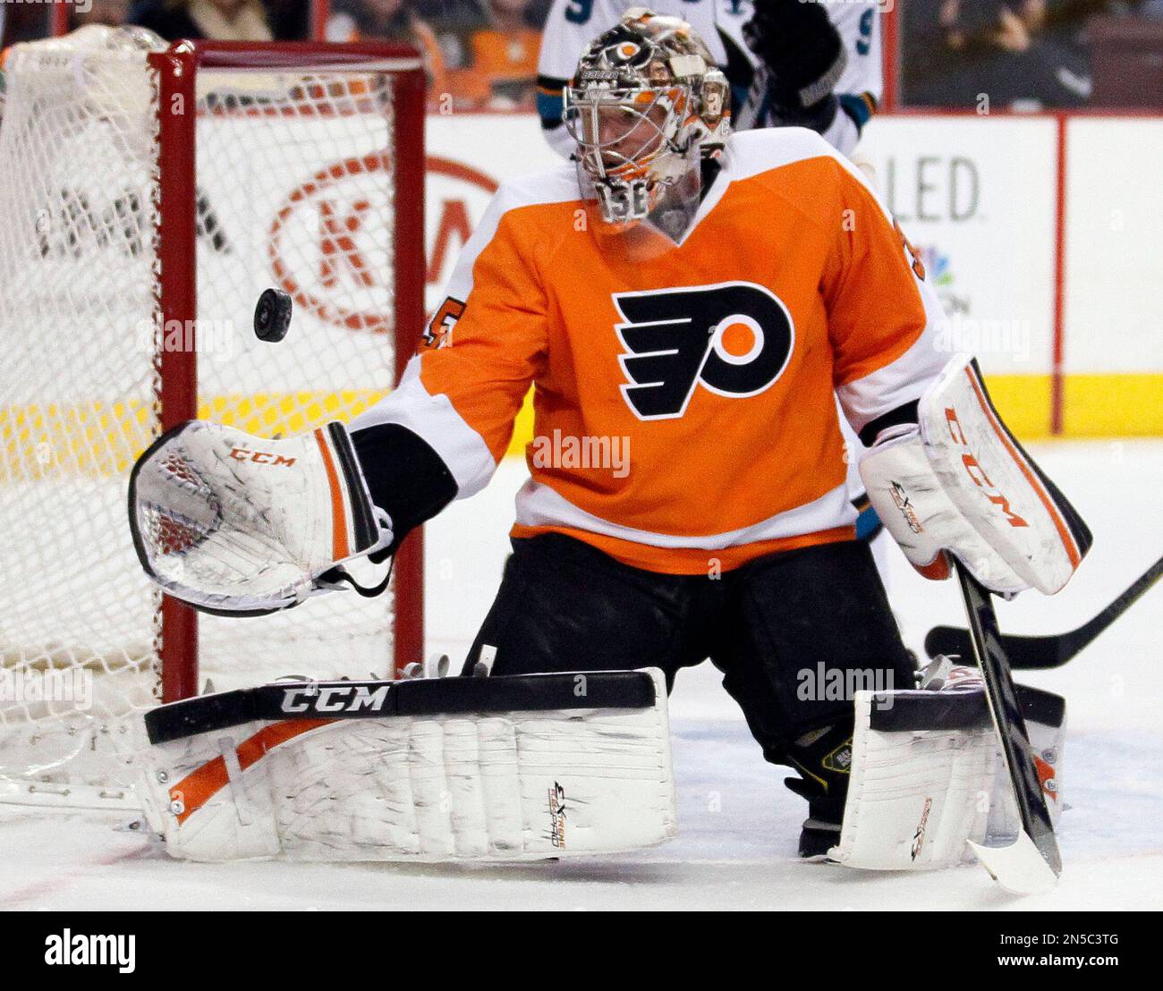 Philadelphia Flyers goalie Steve Mason reaches for the puck during the ...