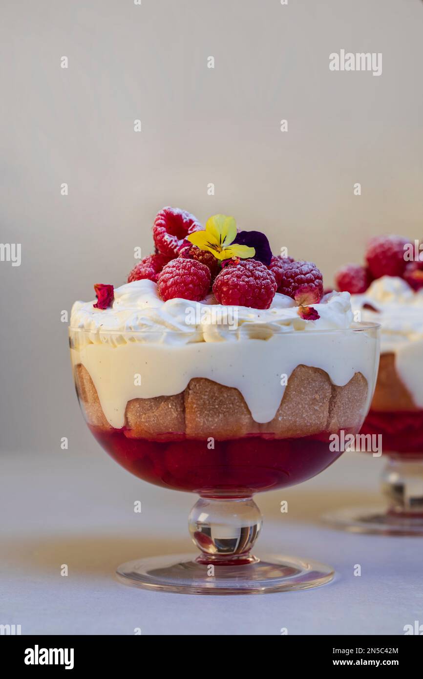 Raspberry trifle with fruit jelly, custard and cream Stock Photo - Alamy