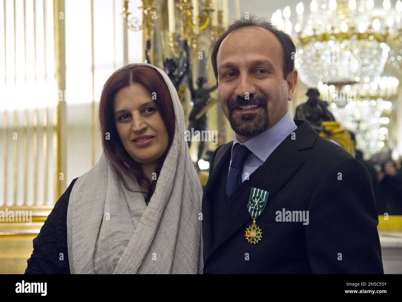 Iranian film director Asghar Farhadi, right, and his wife Parisa, left, pose after he was ...