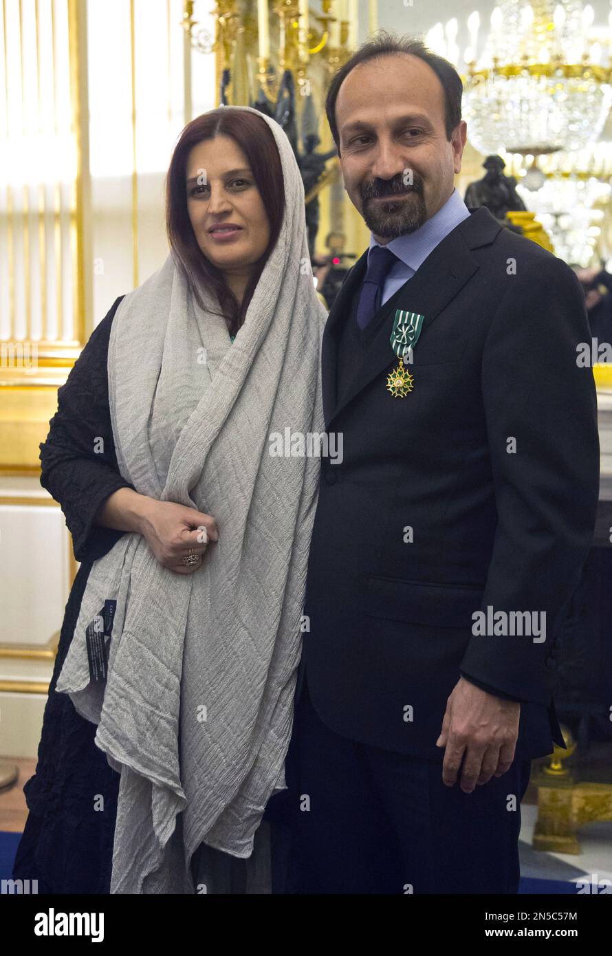 Iranian film director Asghar Farhadi, right, and his wife Parisa, left, pose after he was ...