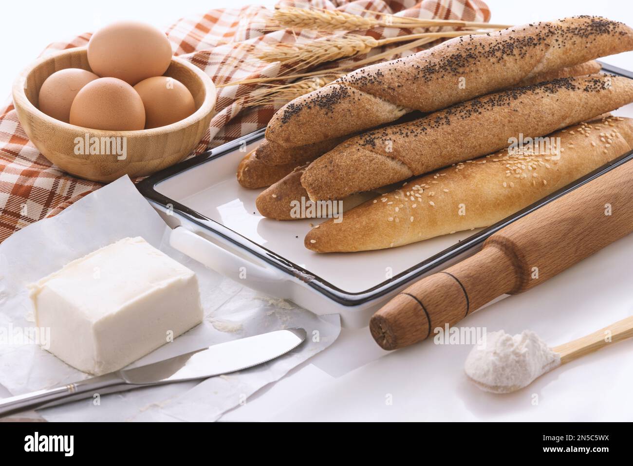 Freshly baked crusty homemade butter rolls or baked horns with eggs and ...