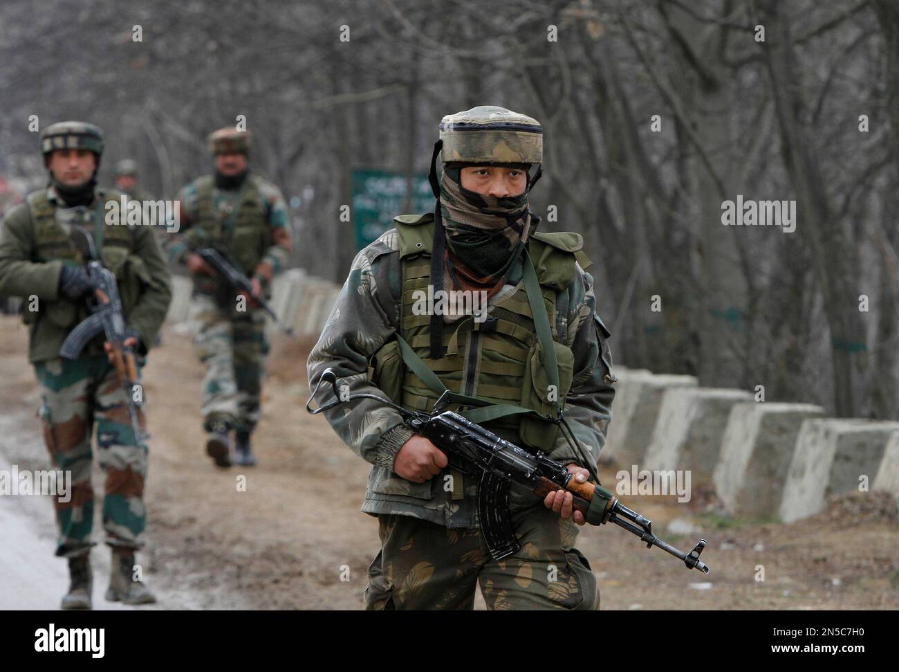 Indian army soldiers patrol outside their base camp at Safapora ...