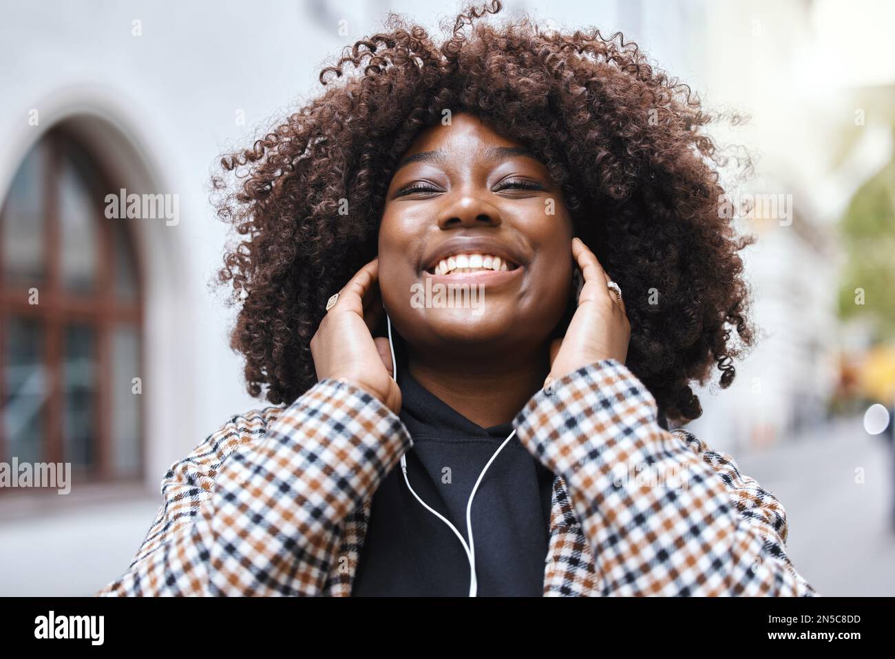 Freedom, city and black woman listening to music, radio or song in the ...