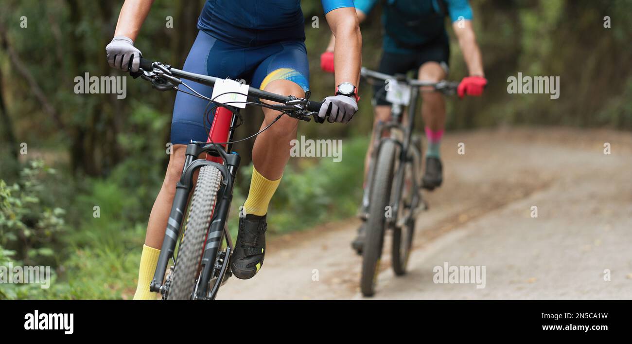 Mountain bikers riding on bike singletrack trail, mountain bike race ...