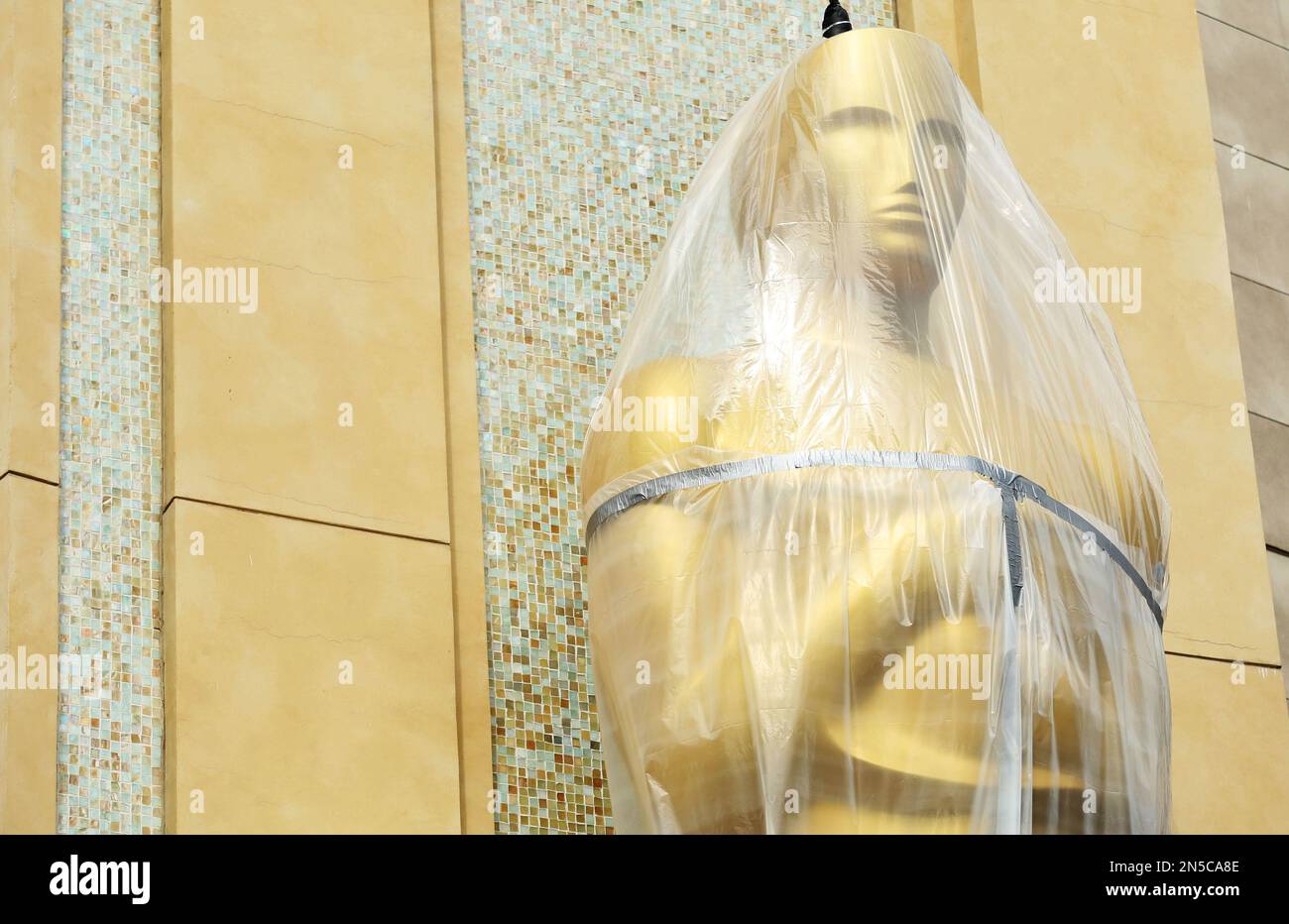 An Oscar statue is covered in plastic as preparations are made for the ...