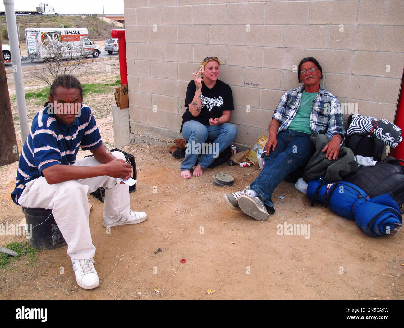 In this photo from Feb. 24, 2014, three homeless people, from left ...