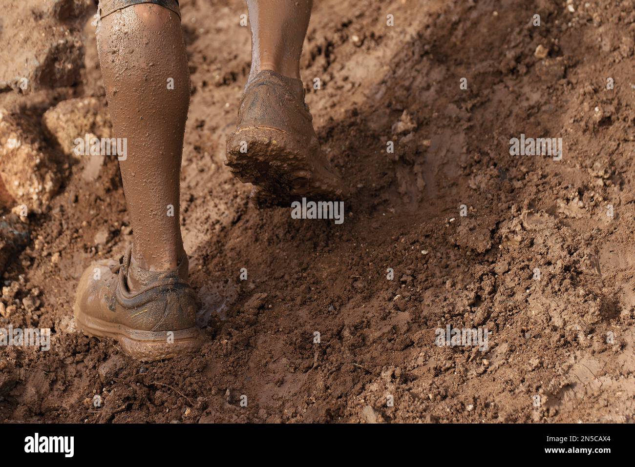 Mud race runner very muddy running shoes, muddy feet detail Stock Photo ...