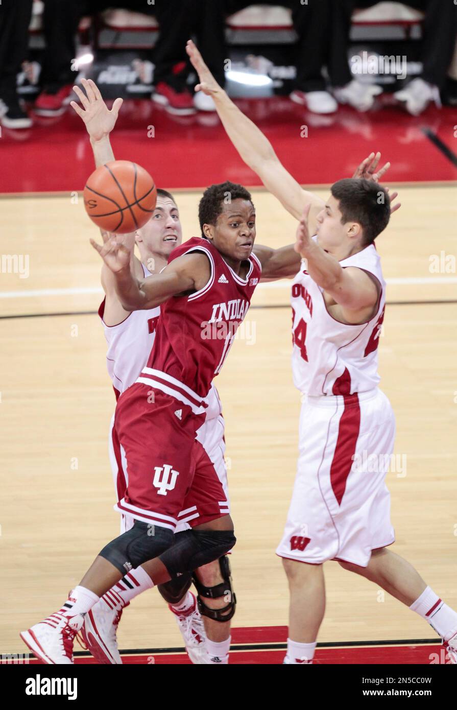 Indiana's Kevin Yogi Ferrell, center, passes against Wisconsin's Josh ...