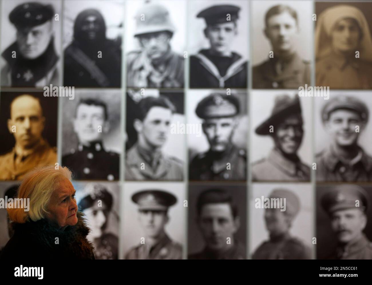 A visitor looks at an exhibition entitled 'The Great War in Portraits ...