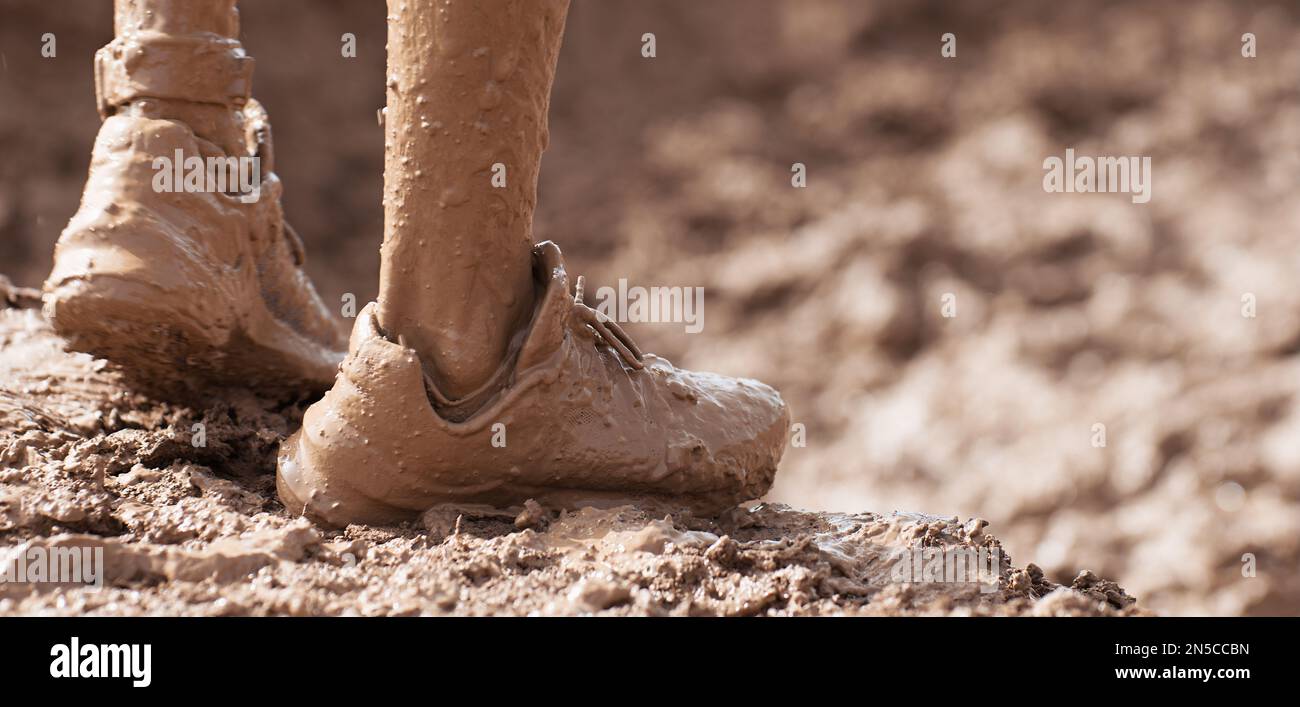 Mud race runner very muddy running shoes, muddy feet detail Stock Photo ...