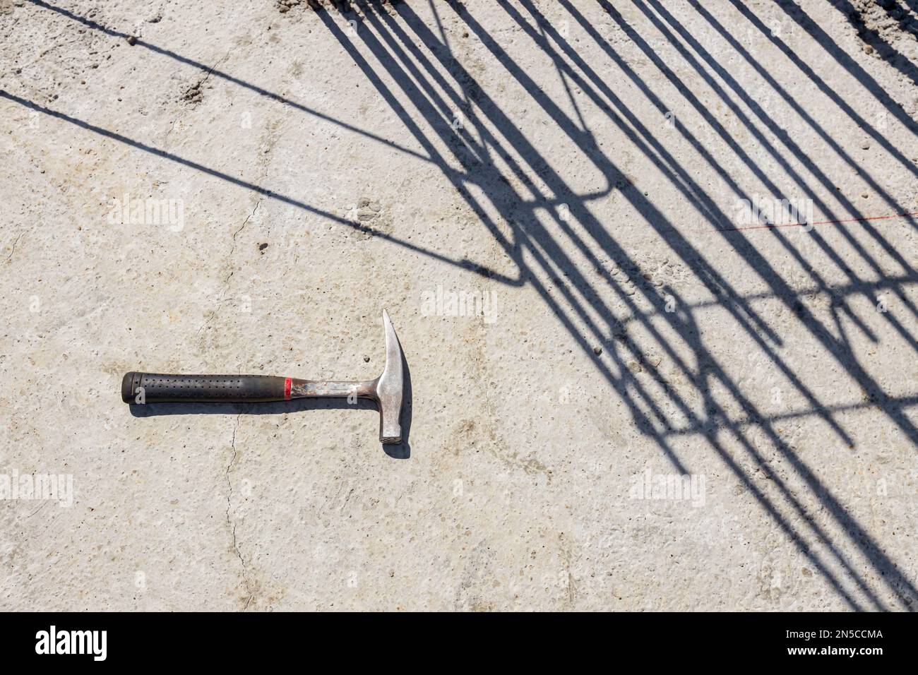 Used tool, mason's hammer, metal handled with rubber, placed on ...