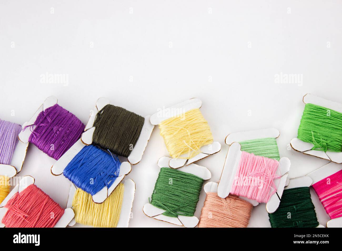 Skeins of cotton threads of different colors lie at the bottom of the ...