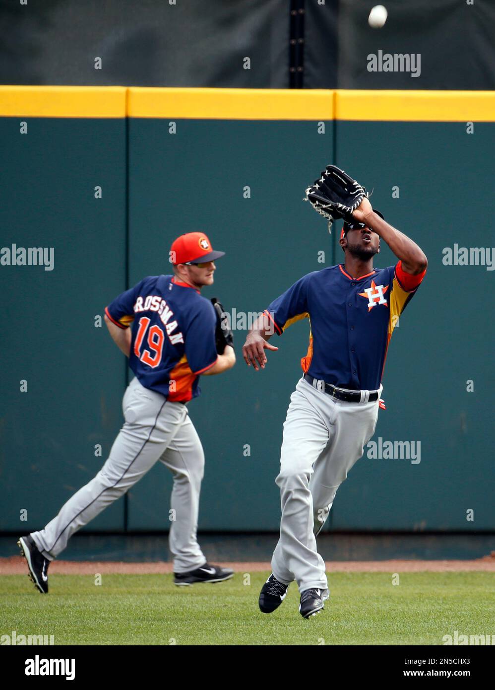 Houston Astros outfielder Dexter Fowler, right, catches a fly ball in ...