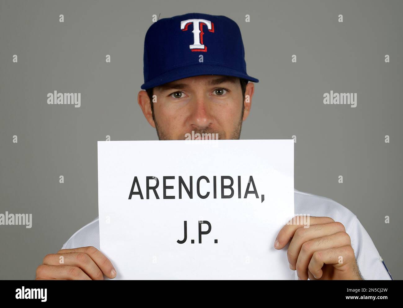 Texas Rangers' J.P.Arencibia peers over his name sheet before posing ...