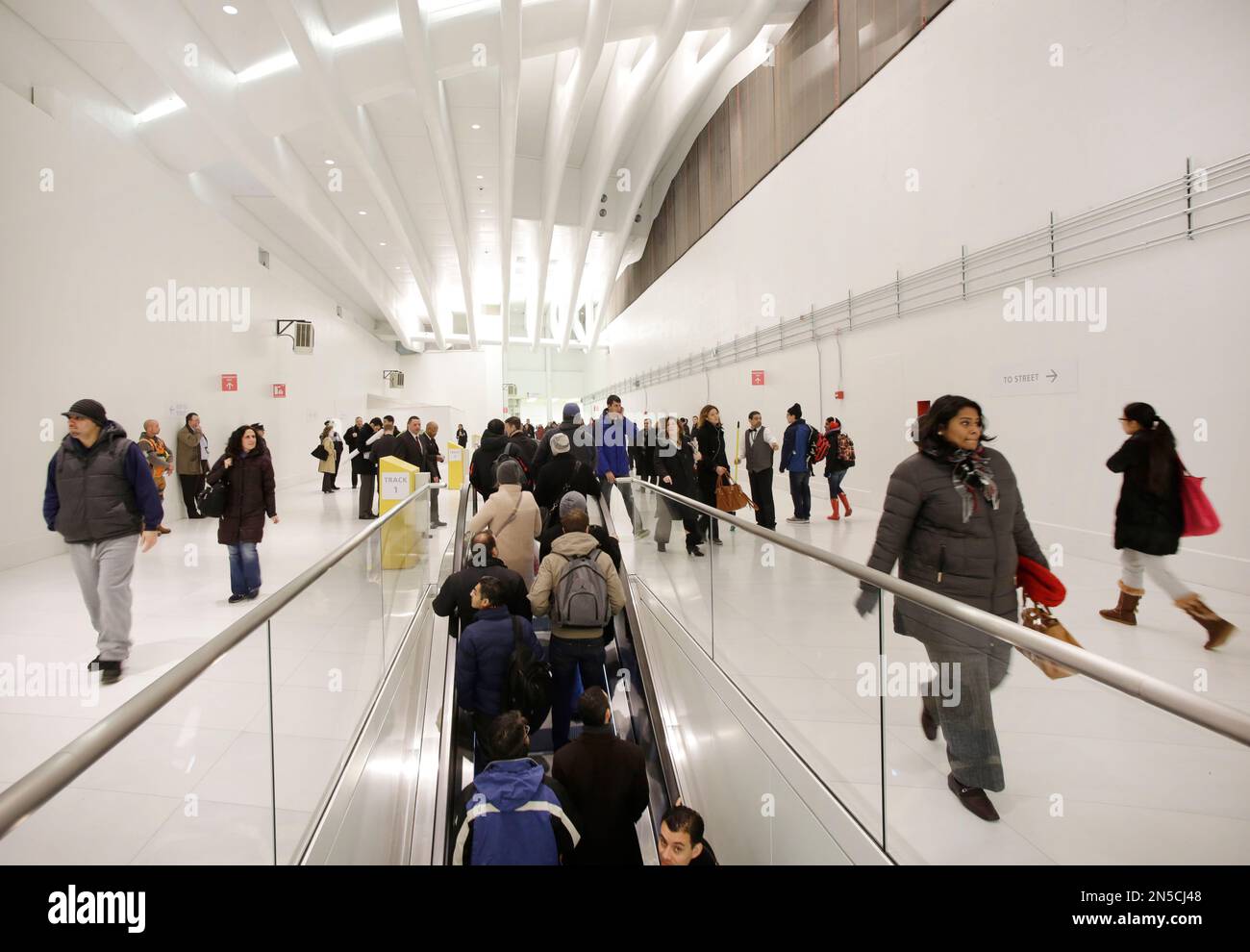 Commuters walk through the concourse area of a newly-opened section of ...