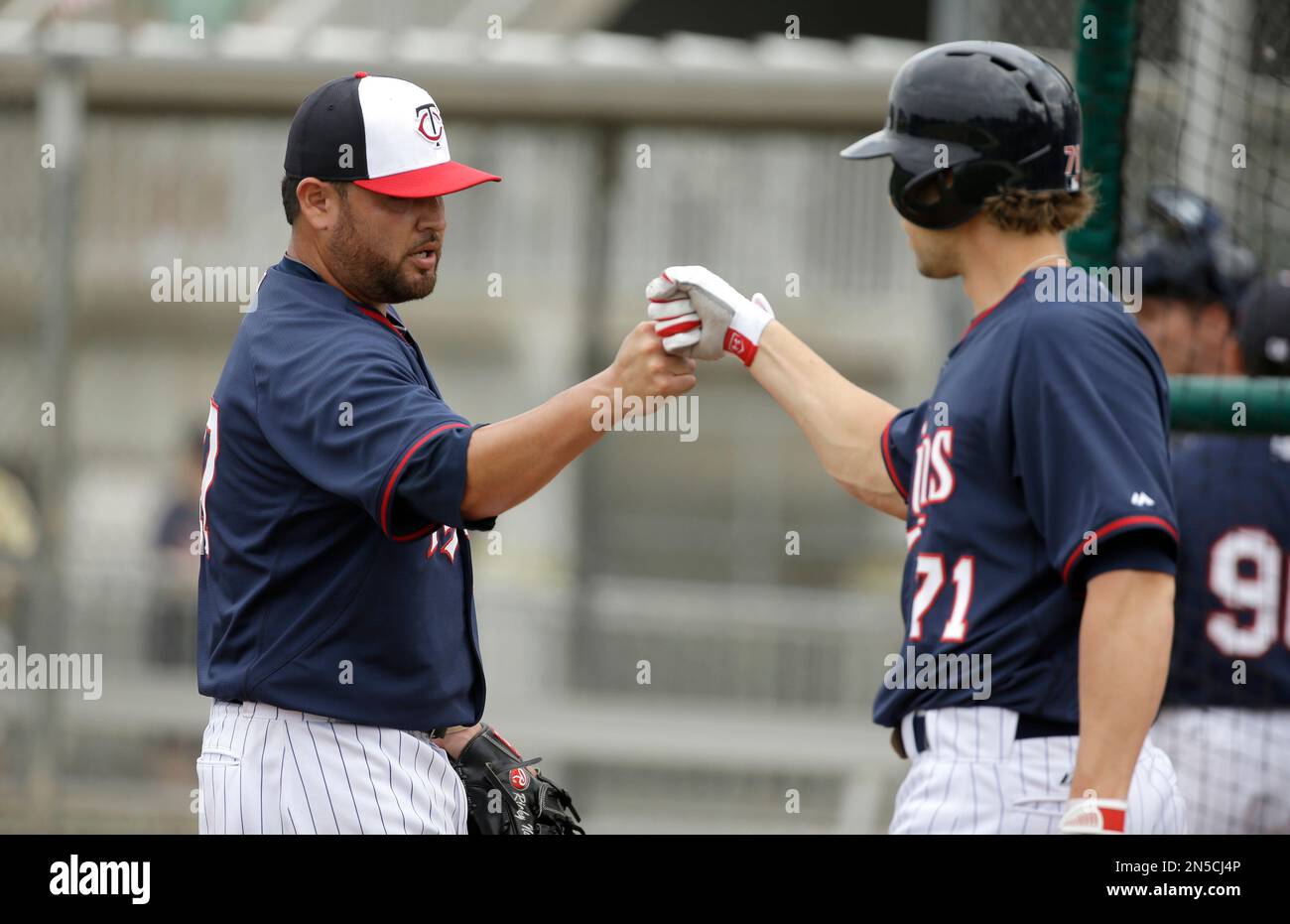 Minnesota Twins starting pitcher Ricky Nolasco, left, bumps fists with ...