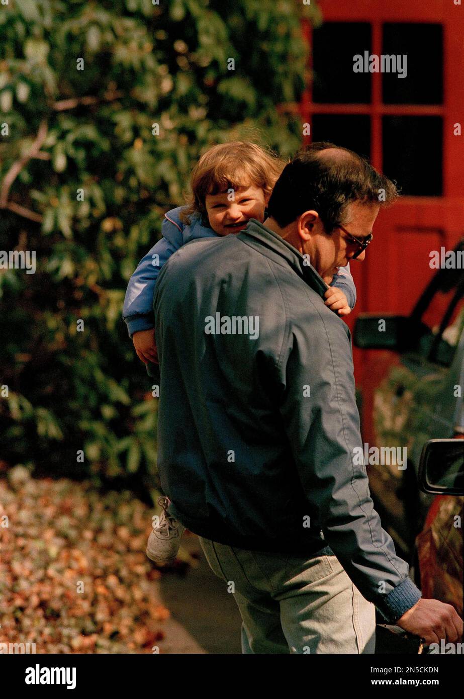 A smiling Melissa Stern is carried by her father, William Stern, from their home in Tenafly, N.J ...
