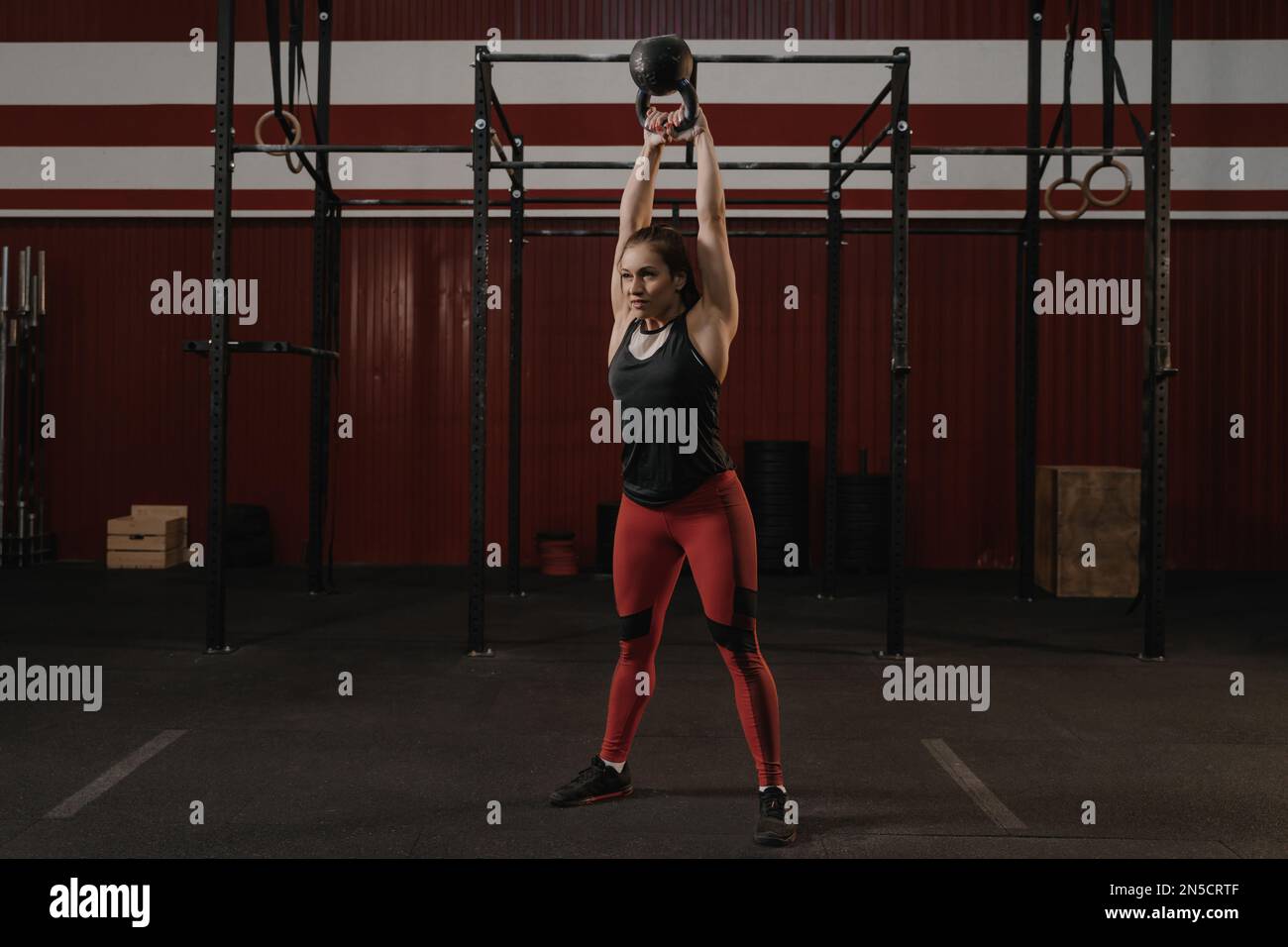 Young caucasian sports woman doing kettlebell swing exercise as a ...