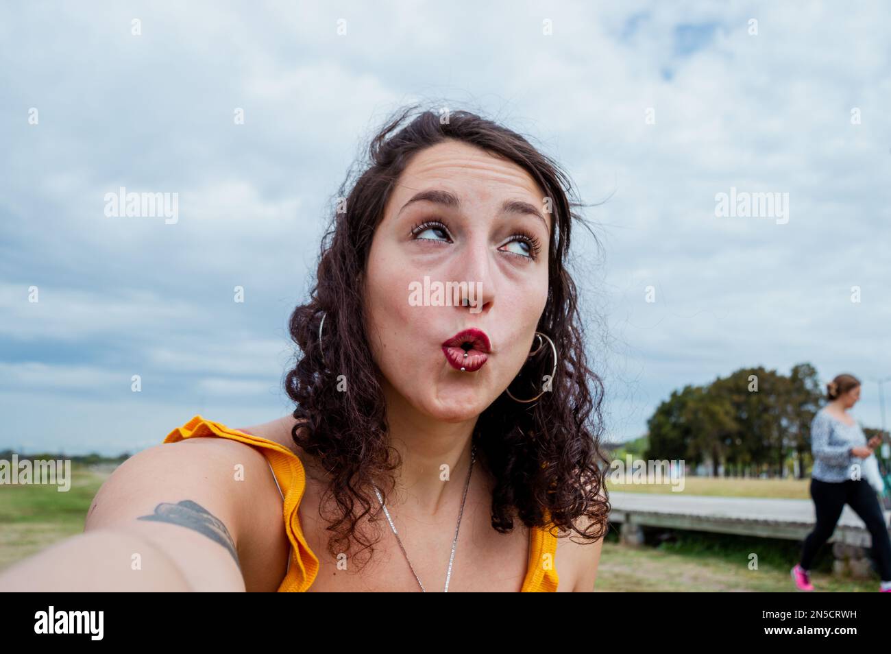 Selfie Portrait Of Young Latin Argentinian Woman Doubting Surprised With Open Mouth And Looking