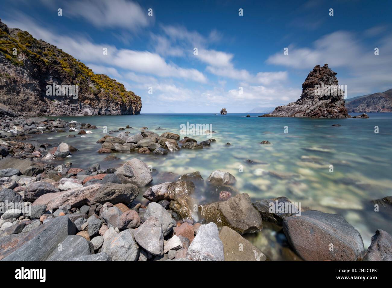 Volcanic bay with a view of the stack and Lipari and Salina in the ...