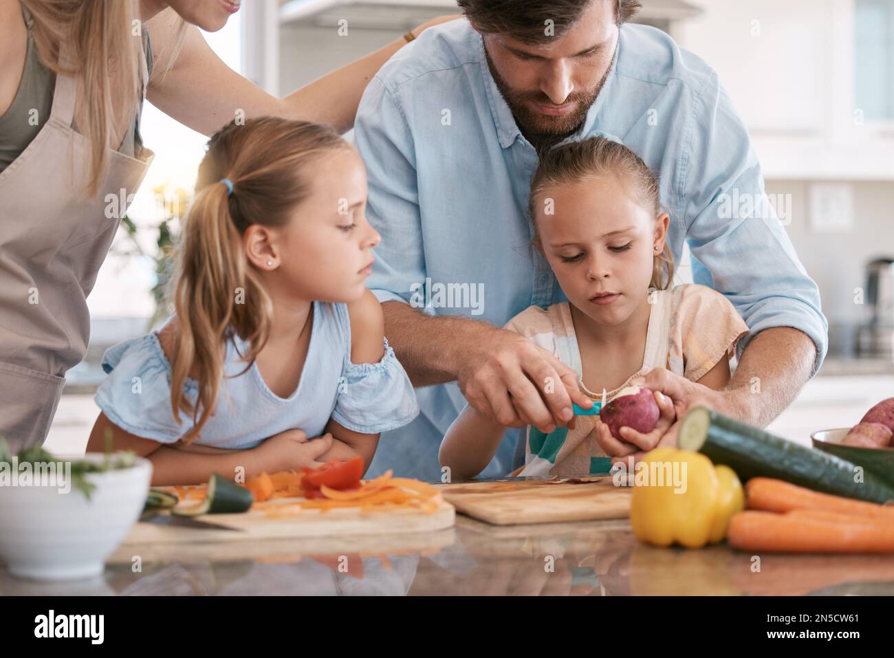 Cooking, kitchen and parents with children with vegetables for healthy ...