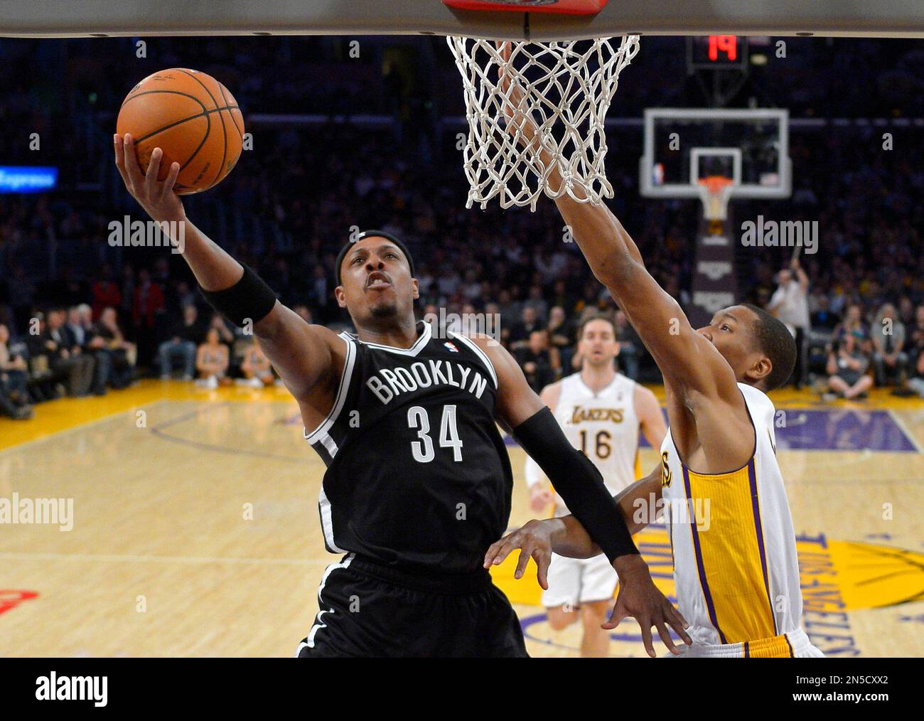 Brooklyn Nets forward Paul Pierce, left, puts up a shot as Los Angeles ...