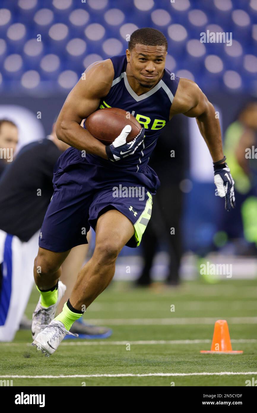 West Virginia running back Charles Sims runs a drill at the NFL ...